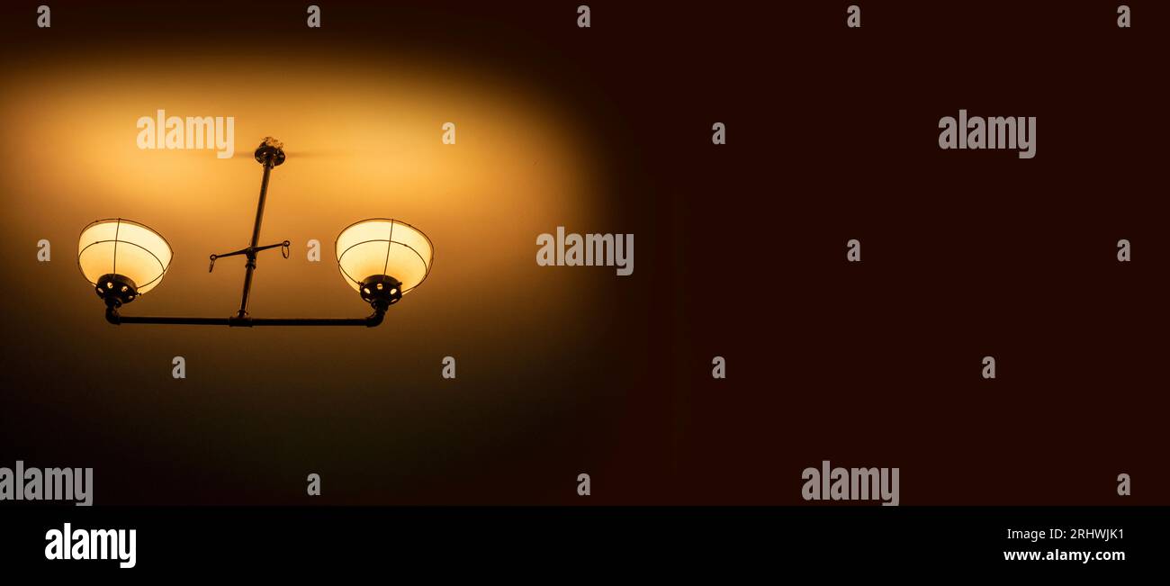 Old ancient lamps on the wall in a dark room background, gloomy light ...