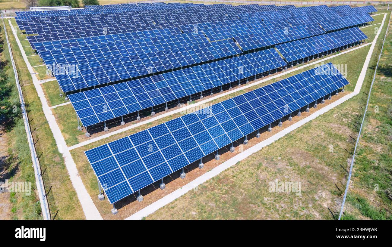 Solar power plant surrounded by a fence. Green energy Stock Photo - Alamy