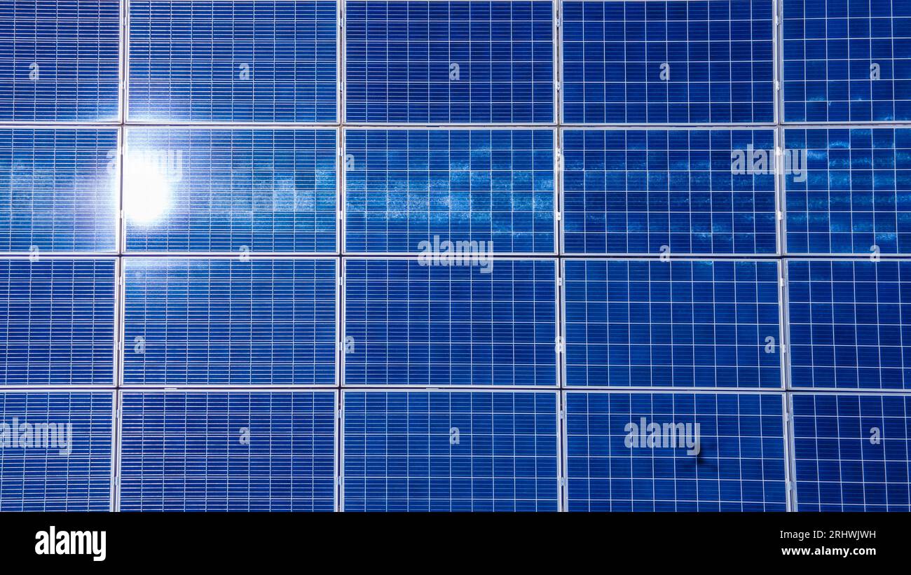 Solar panels with the glare of the sun. Green energy Stock Photo - Alamy