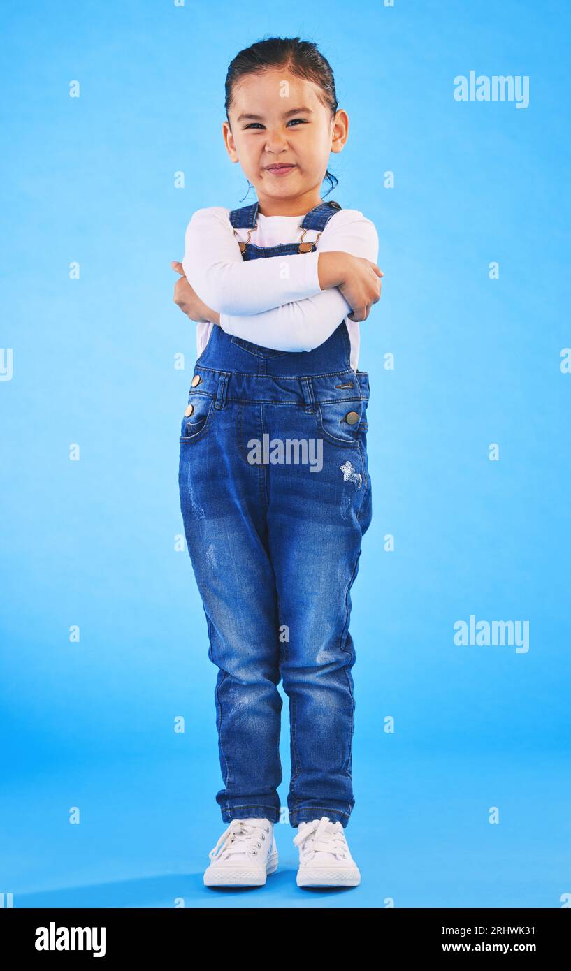 Frustrated, child and arms crossed with tantrum in studio with mockup ...