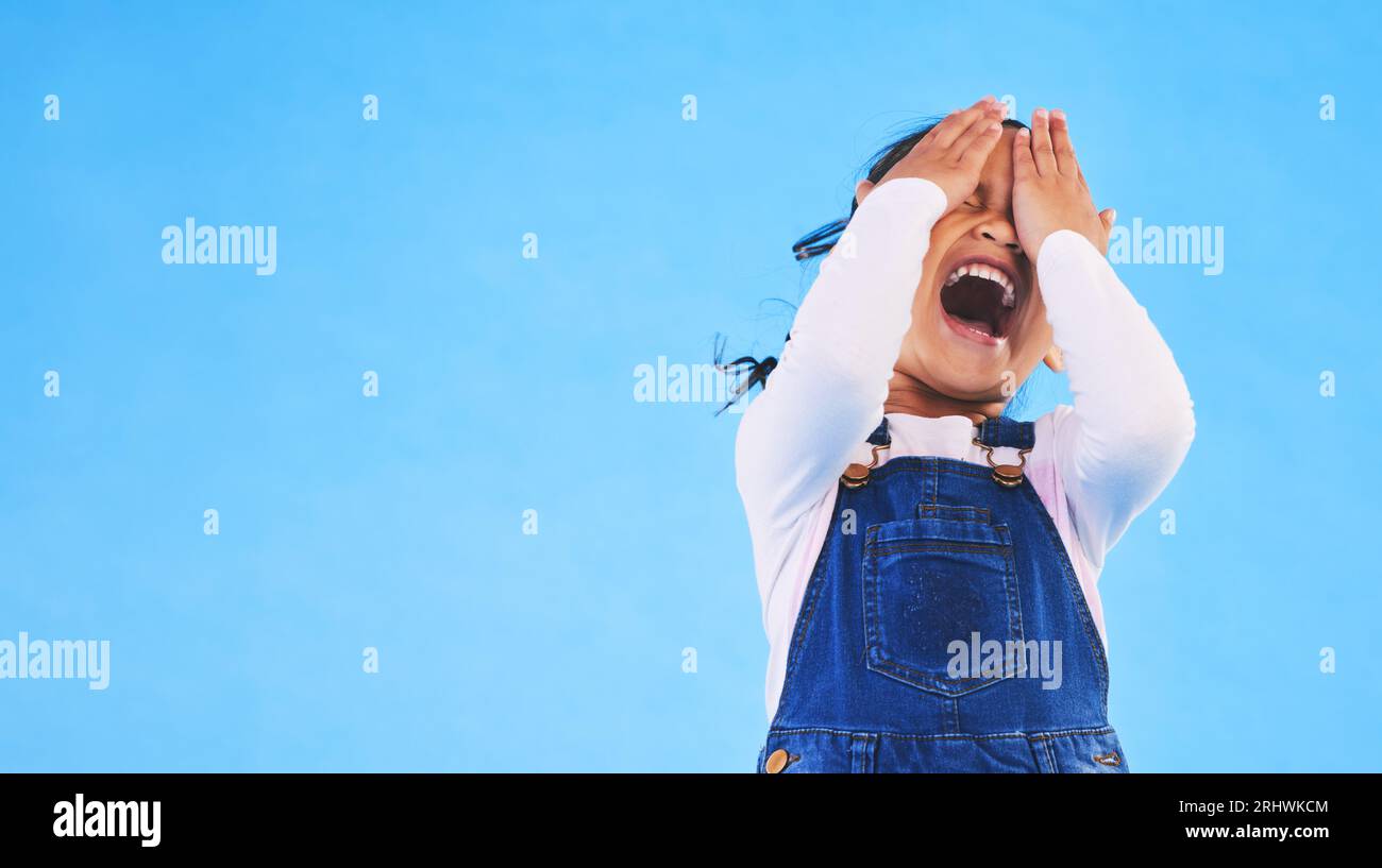 Scared, horror and kid screaming, cover face and studio isolated on a ...