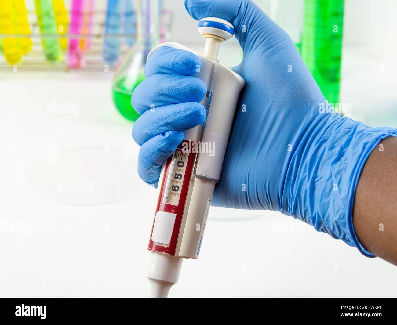 A close up of female hands holding a micropipette showing the different ...