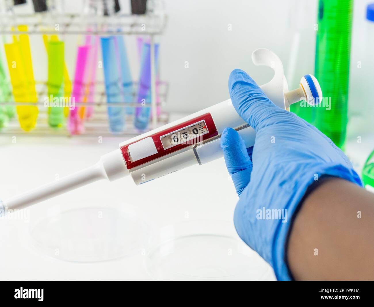 A close up of female hands holding a micropipette showing the different ...