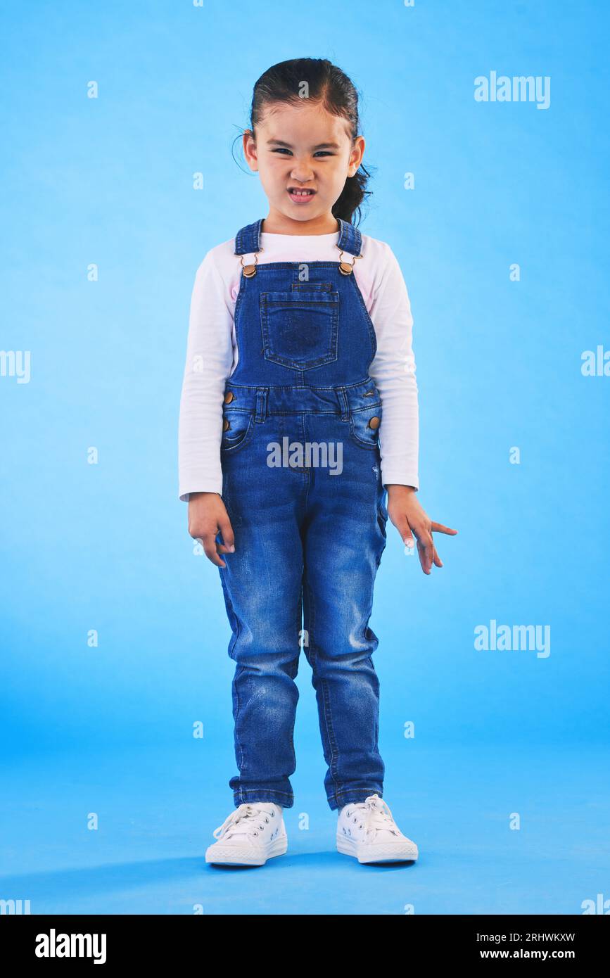 Angry, attitude and portrait of child on blue background with upset ...