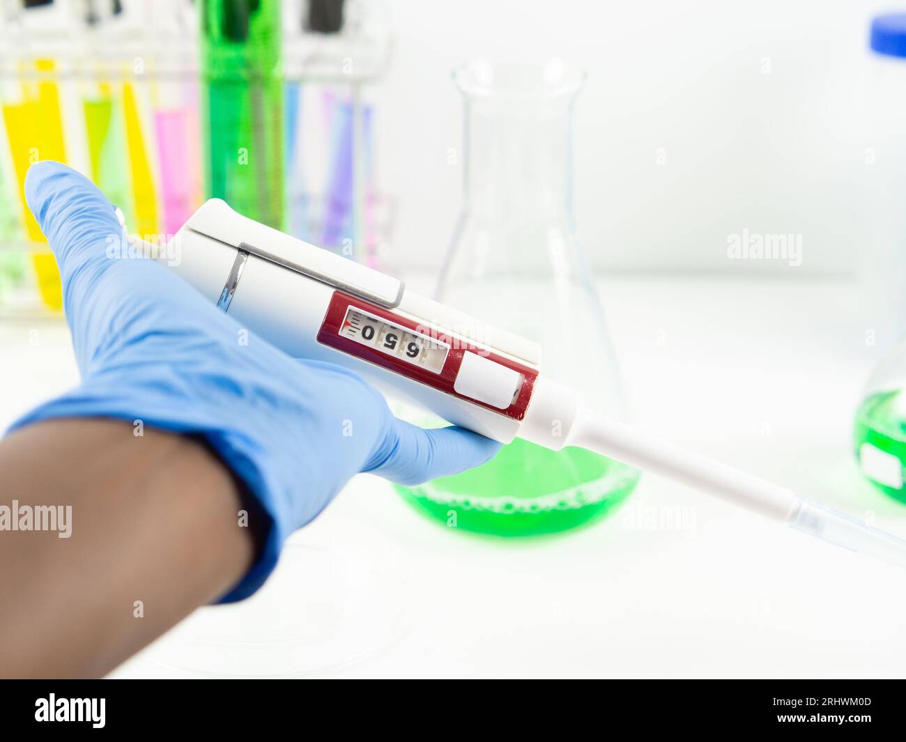 A close up of female hands holding a micropipette showing the different ...