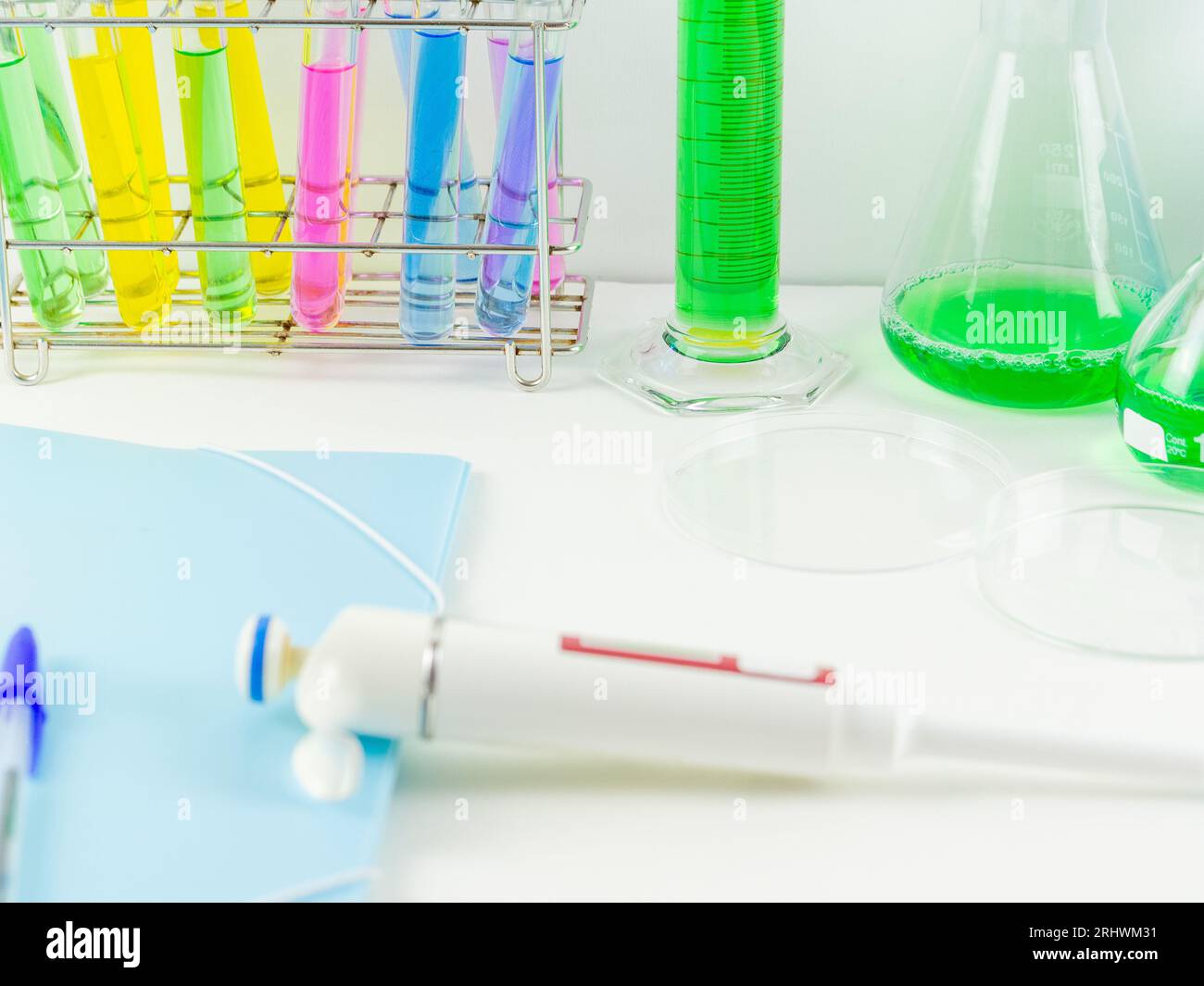 laboratory equipment and glassware on display with a file and a pen ...