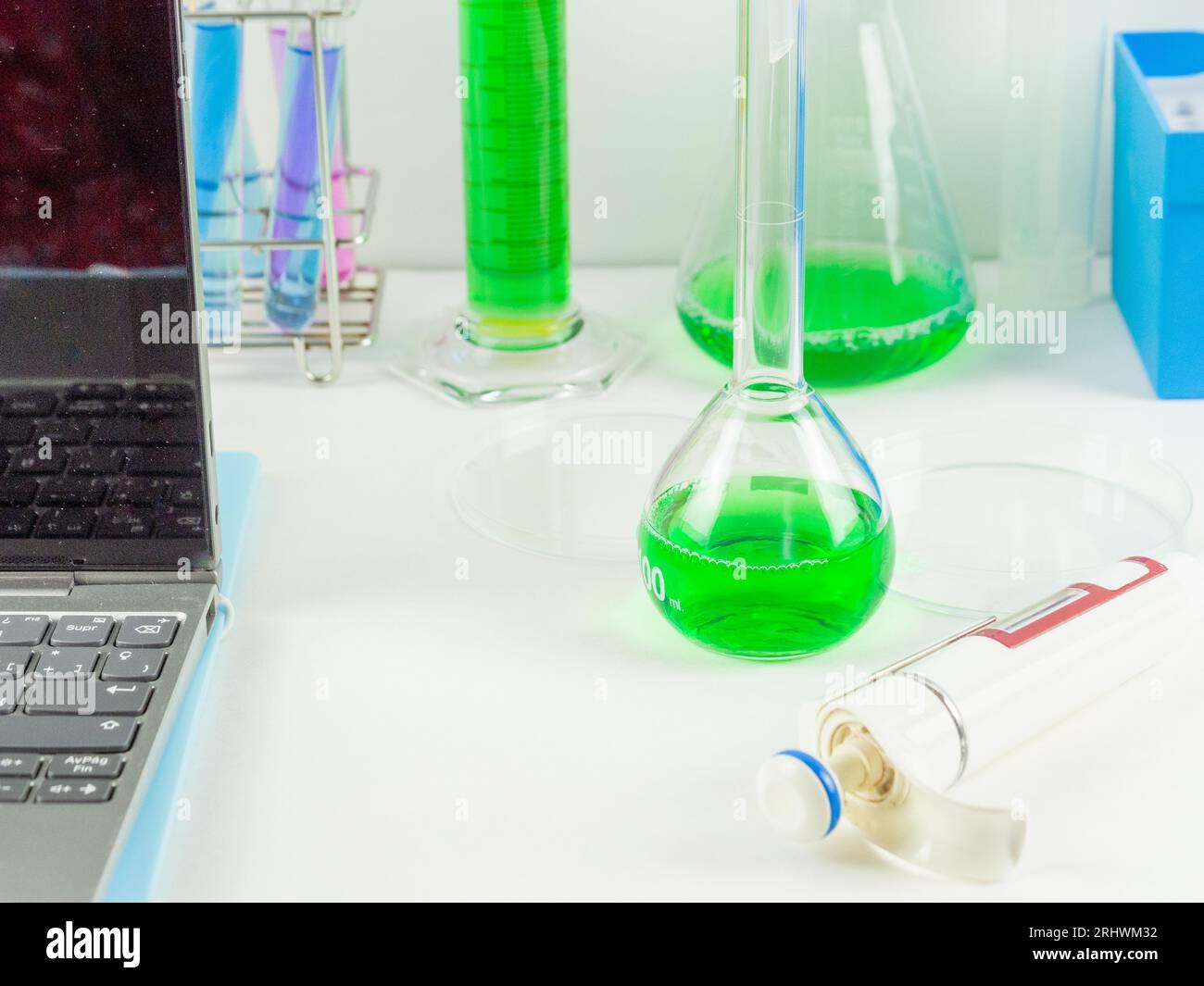 laboratory equipment and glassware on display with a file and a pen ...