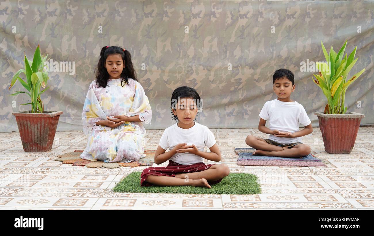 Indian Kids practicing yoga early in the morning, training yoga ...