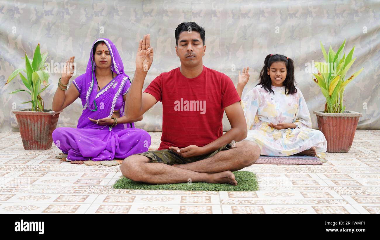 Indian family member doing yoga or meditating while making the Blessing ...