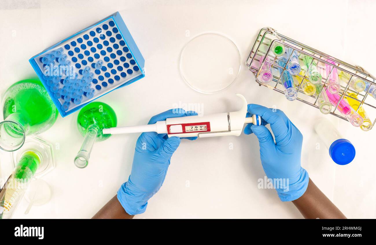 A close up of female hands holding a micropipette showing the different ...