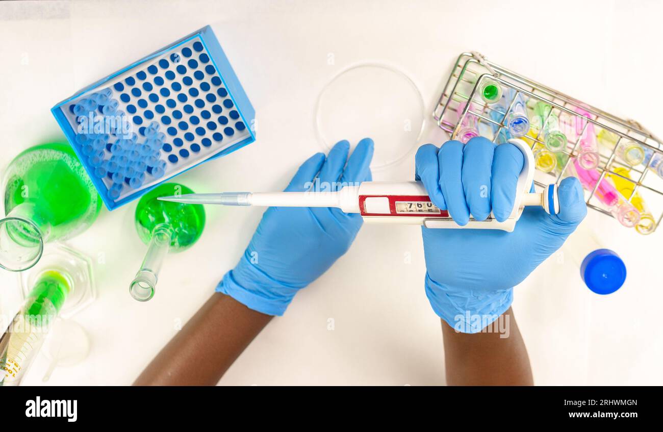 A close up of female hands holding a micropipette showing the different ...