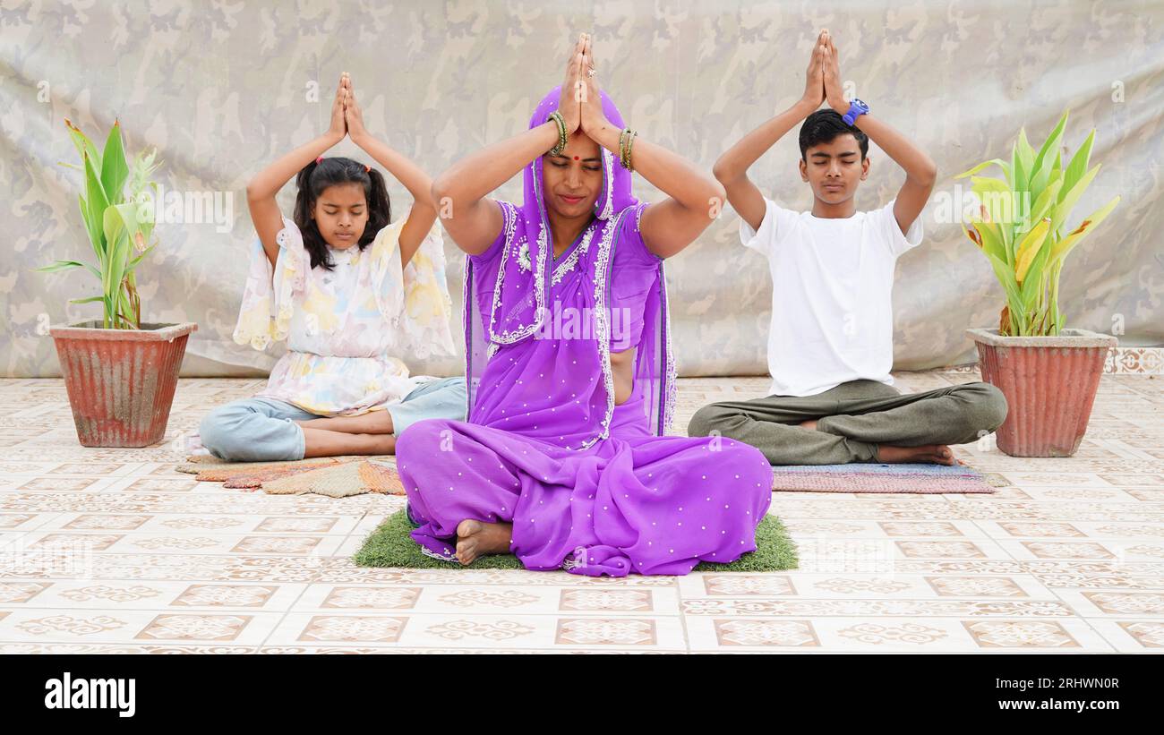 Lotus posture. Young mother and little teenager with closed eyes and ...