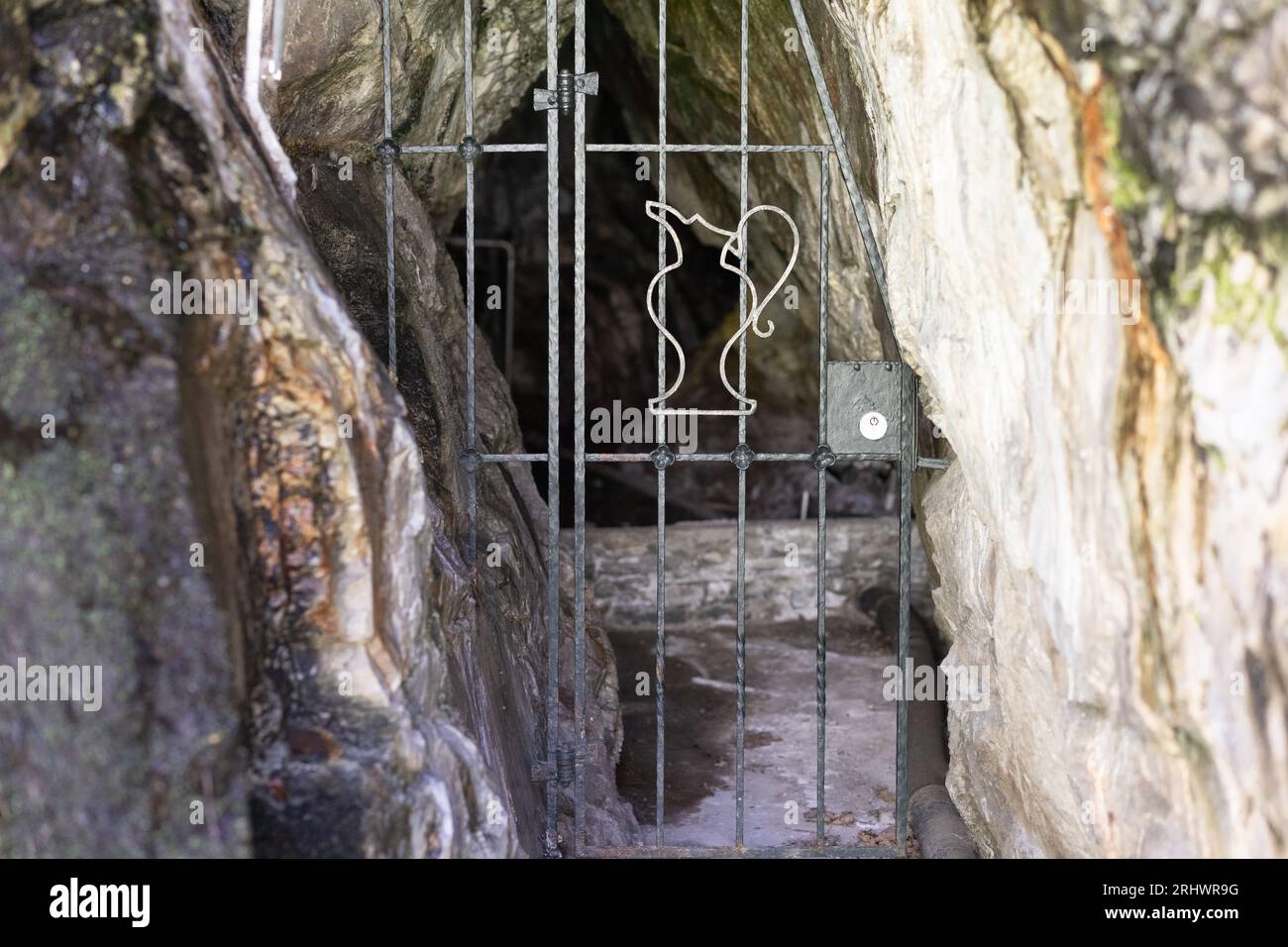 The entrance to the cave with source of mineral water closed with a ...
