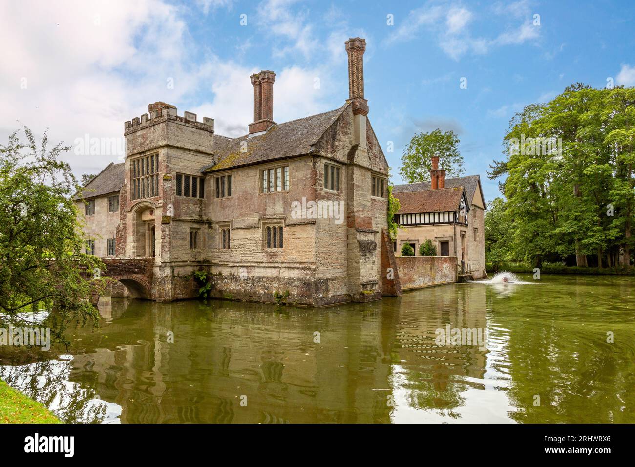 The moated Manor House and grounds in Baddesley Clinton, Warwickshire ...
