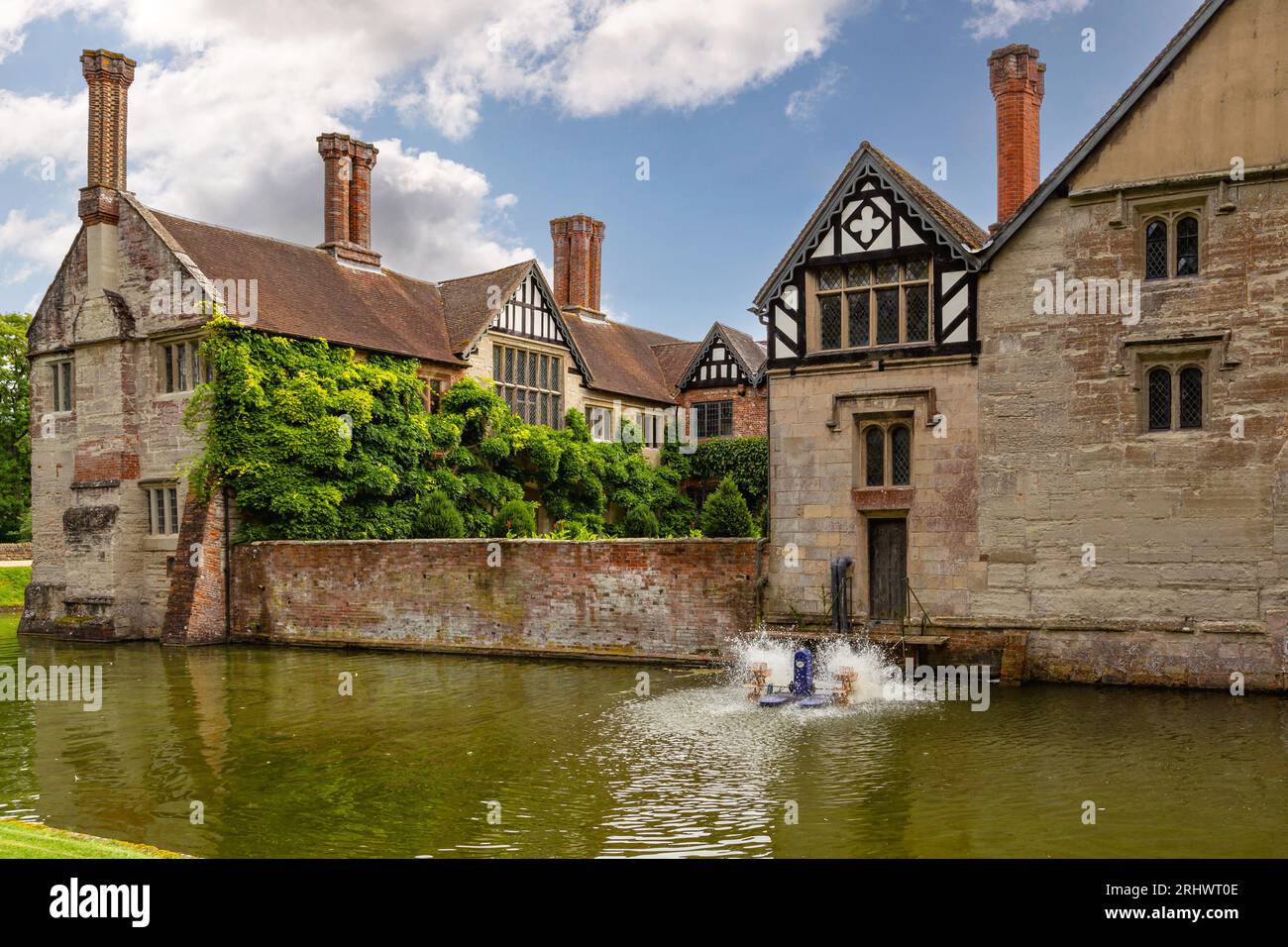 The moated Manor House and grounds in Baddesley Clinton, Warwickshire ...