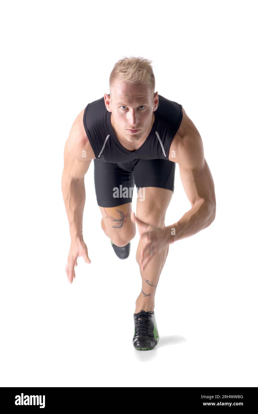 Photo of a blond man with blue eyes performing a dynamic jump in a ...