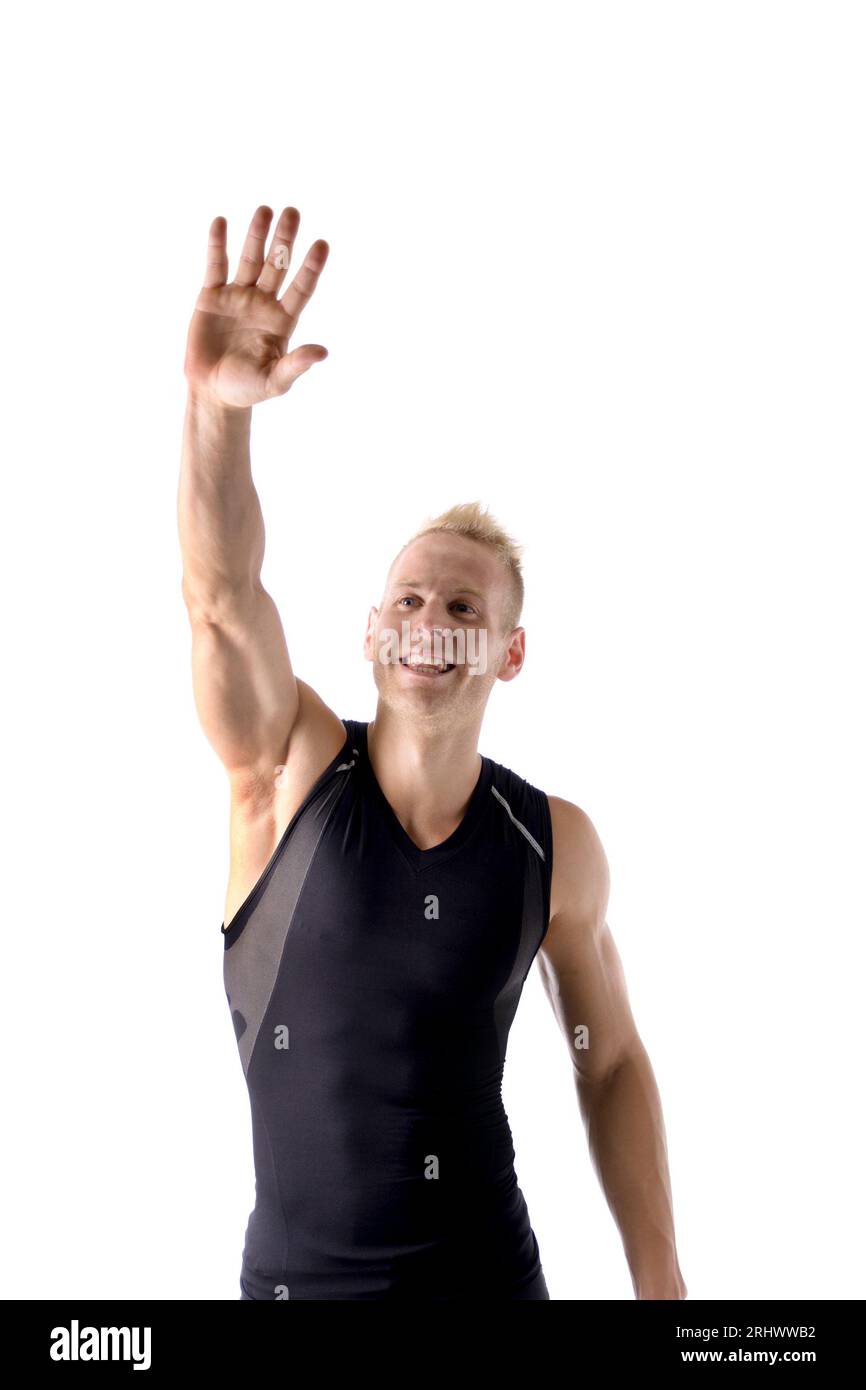 Photo of a blond male with blue eyes posing in a studio, raising his ...