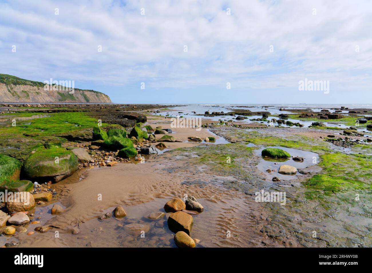 The rock strewn foreshore of Robin Hoods Bay near Whitby in North ...