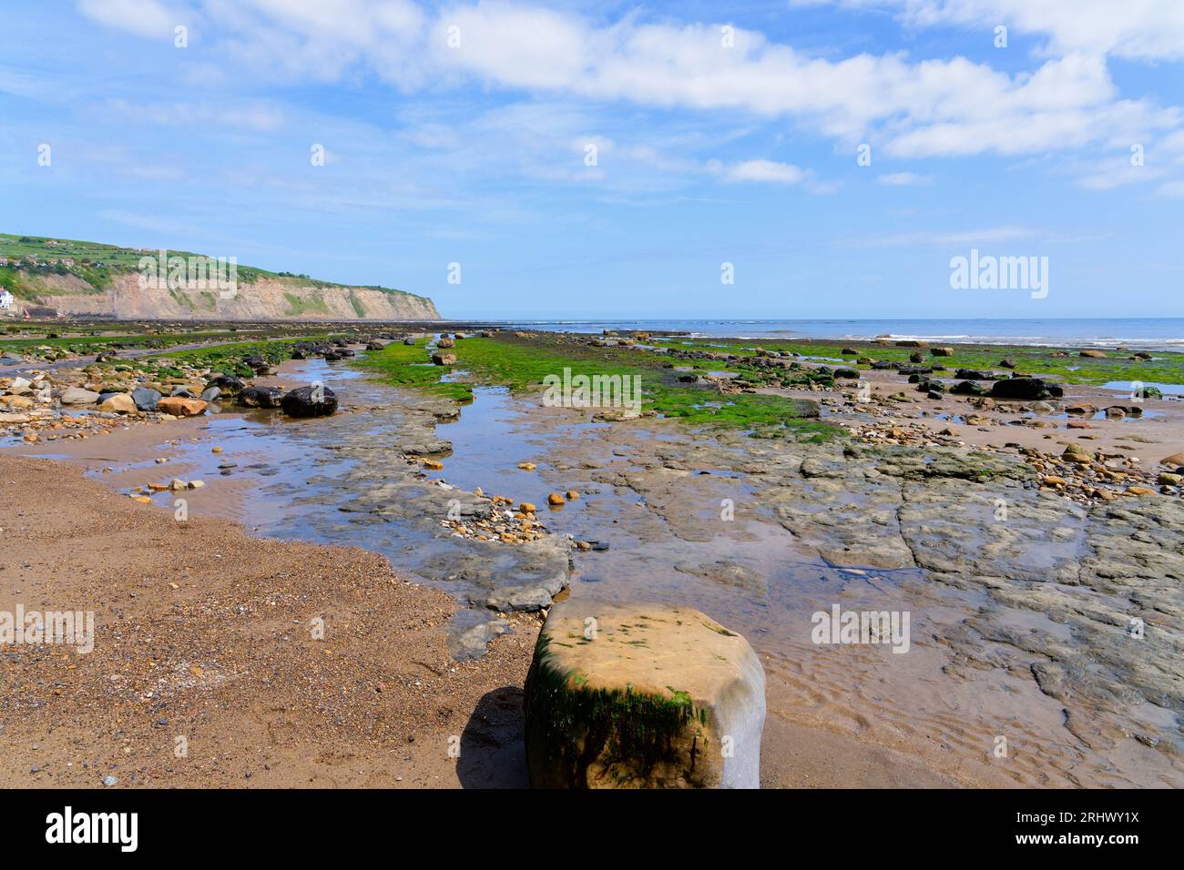 Lots of rock pools to explore at low tide on Robin Hoods Bay beach in ...