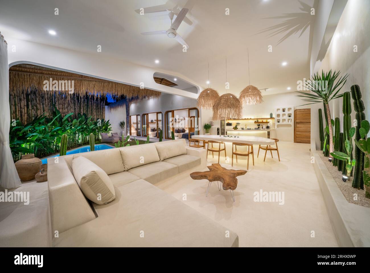 White interior design in living room with open space to garden with the ...