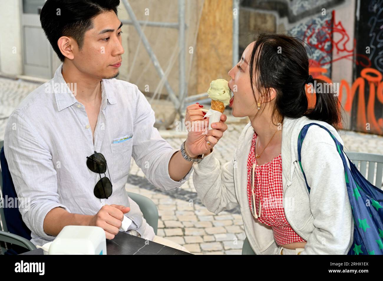 Couple sharing an ice cream Stock Photo - Alamy