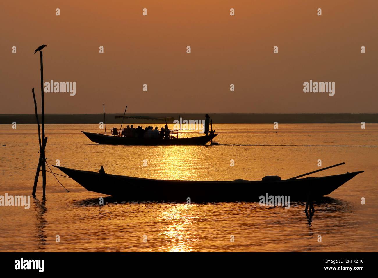 Traditional boats are in the river Padma during sunset time Stock Photo ...