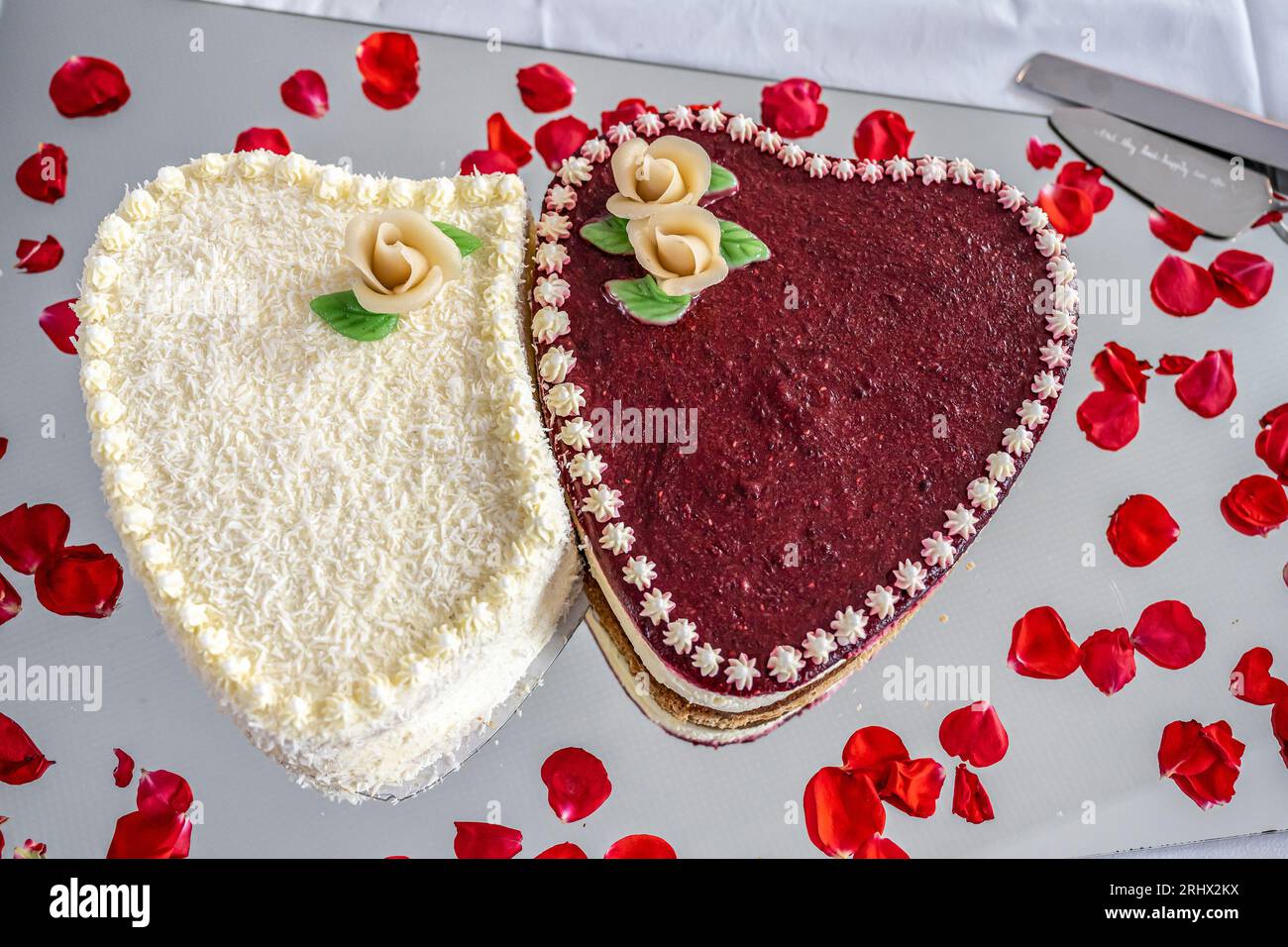 Romantic wedding Two cakes in heart shape, roses bouquet on white table ...