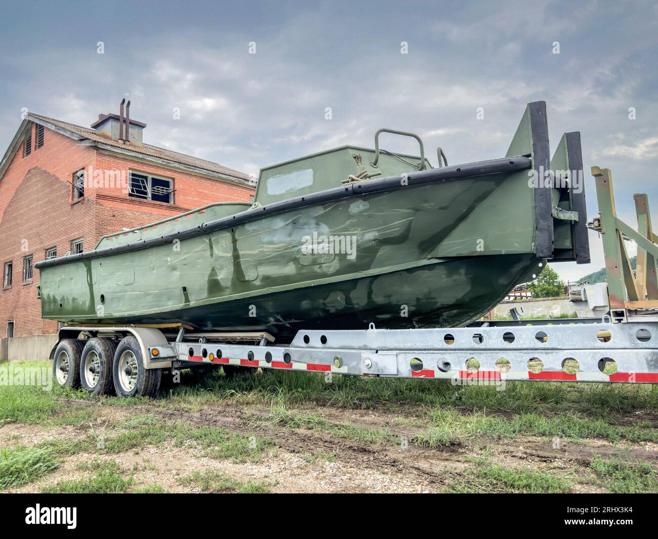 old army decommissioned river boat (bridge erection boat) on a trailer ...