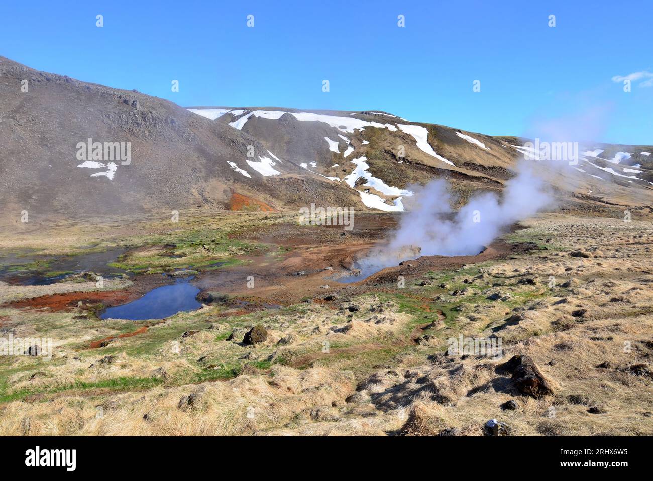 Beautiful landscape with steam rising from geothermal activity ...