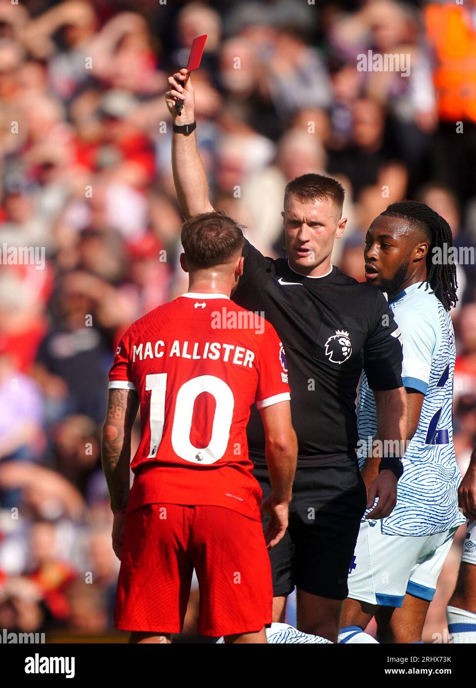 Referee Thomas Bramall shows a red card to Liverpool's Alexis Mac ...