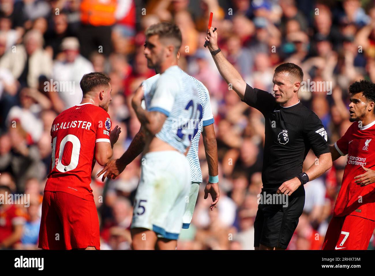 Referee Thomas Bramall shows a red card to Liverpool's Alexis Mac ...