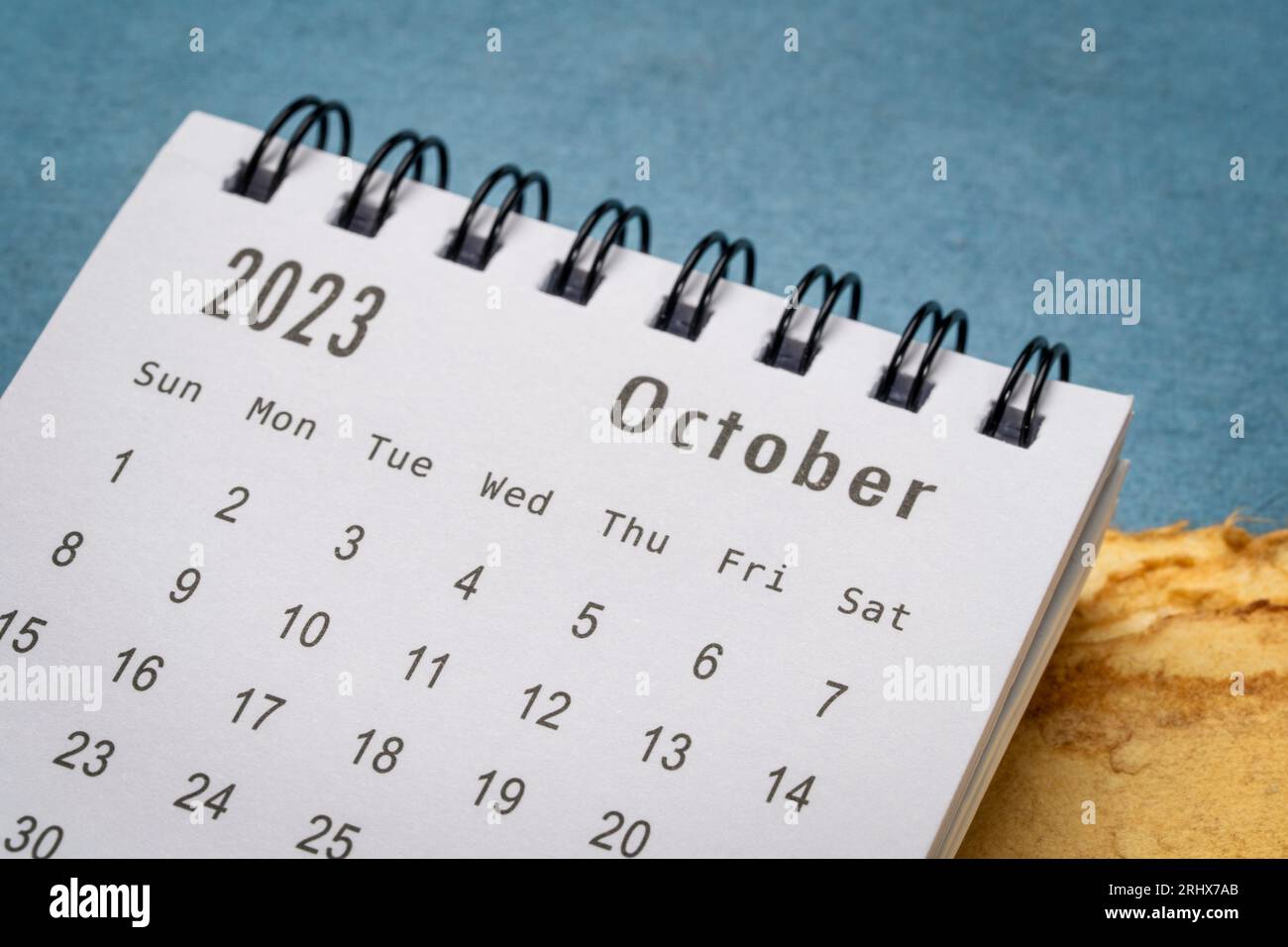 October 2023 - closeup of a small desktop calendar, time and business ...