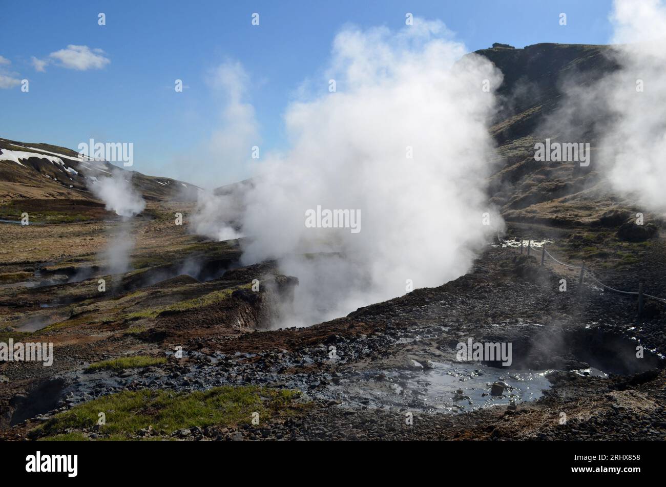 Large clouds of steam rising up from the rugged earths surface in ...