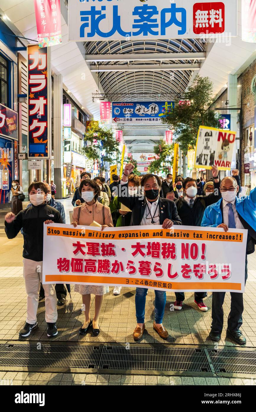 People on protest march through a shopping arcade in Kumamoto. Japan ...