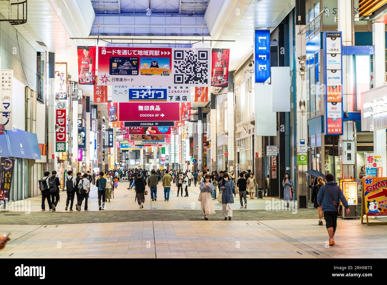 Evening view along the interior of the busy Shimotori shopping arcade ...
