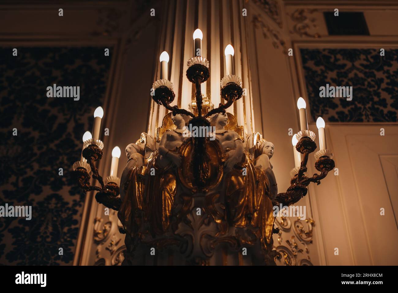 Vintage brownish gold interior details with marble statues and burning ...