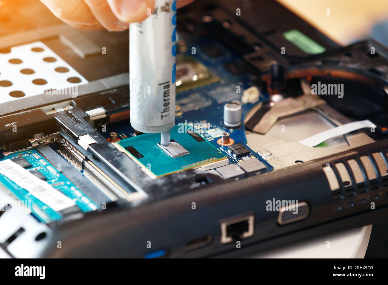 Hand a repairman uses thermal paste syringe apply thermal compound to a ...