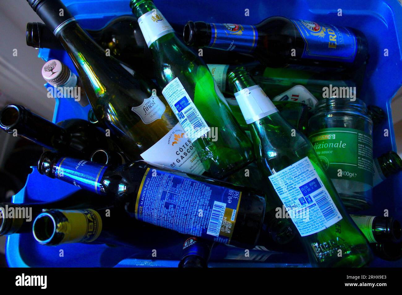 A photo of a number of green, brown and clear glass bottles of alcohol ...