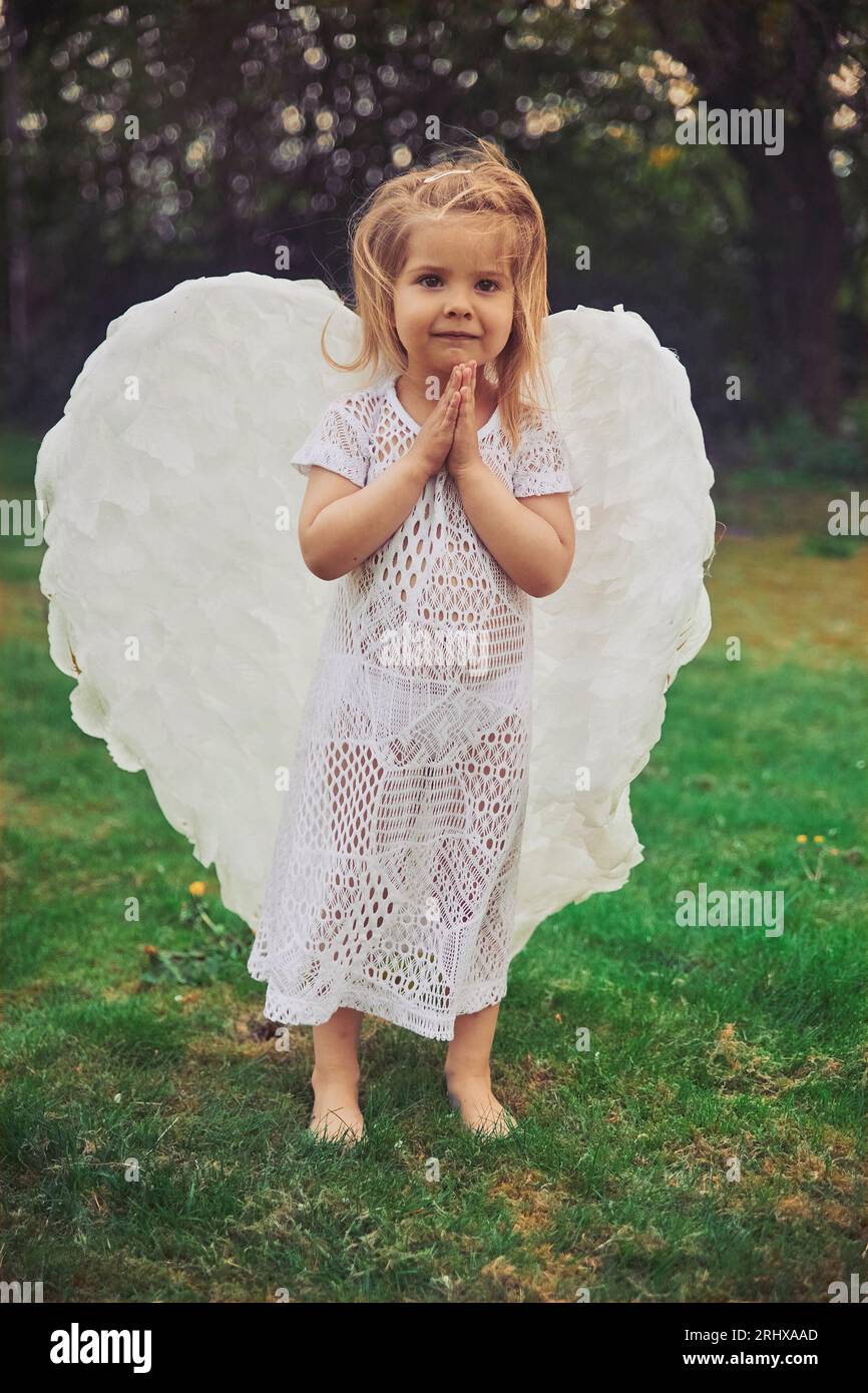 Cute baby dressed as an angel in the evening forest in Denmark Stock ...