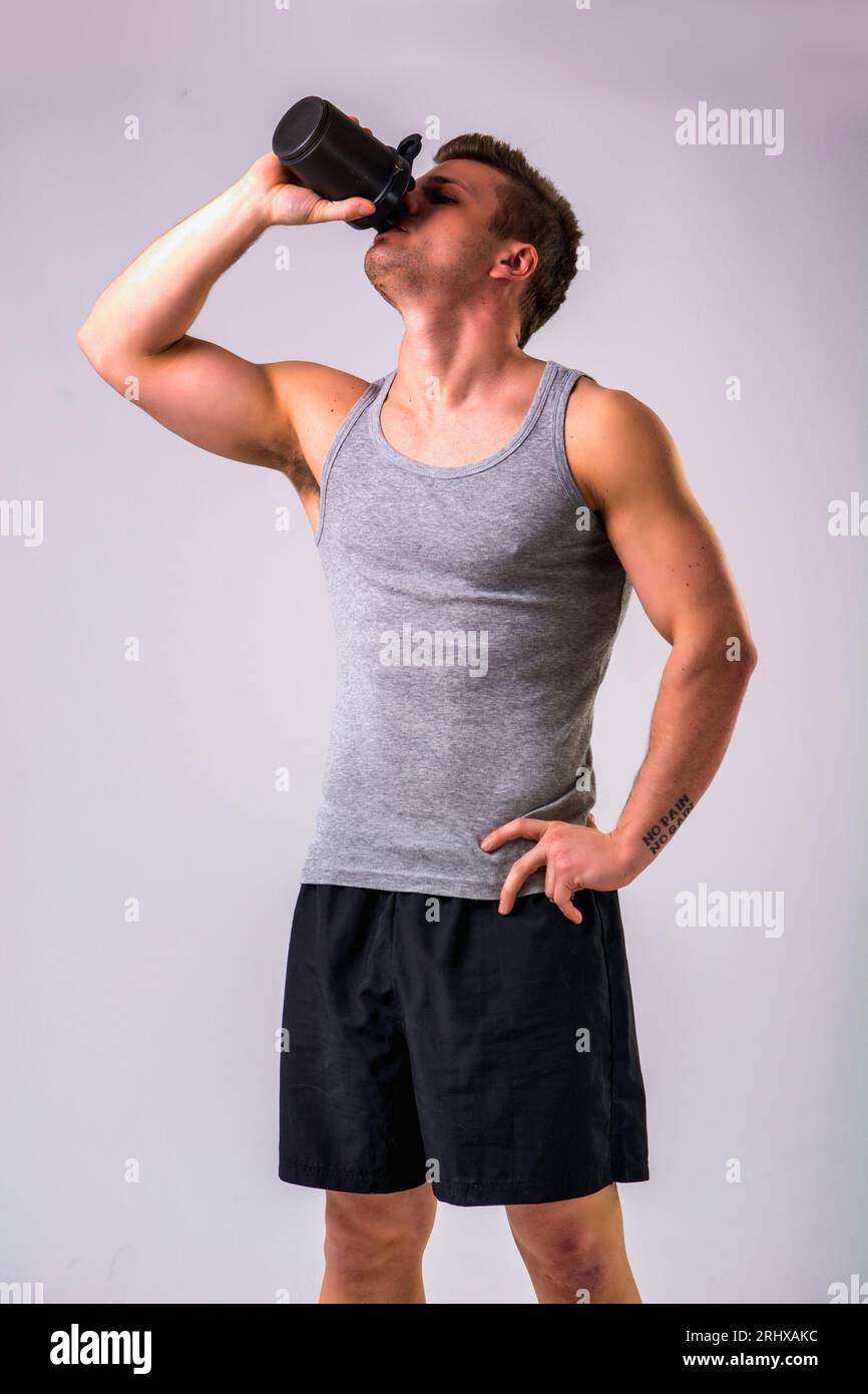 Photo of a man quenching his thirst with a refreshing drink from a ...