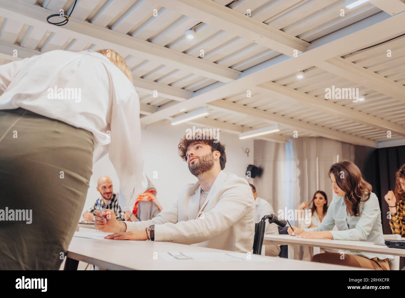 Handicapped male business person having test after training at work. He ...