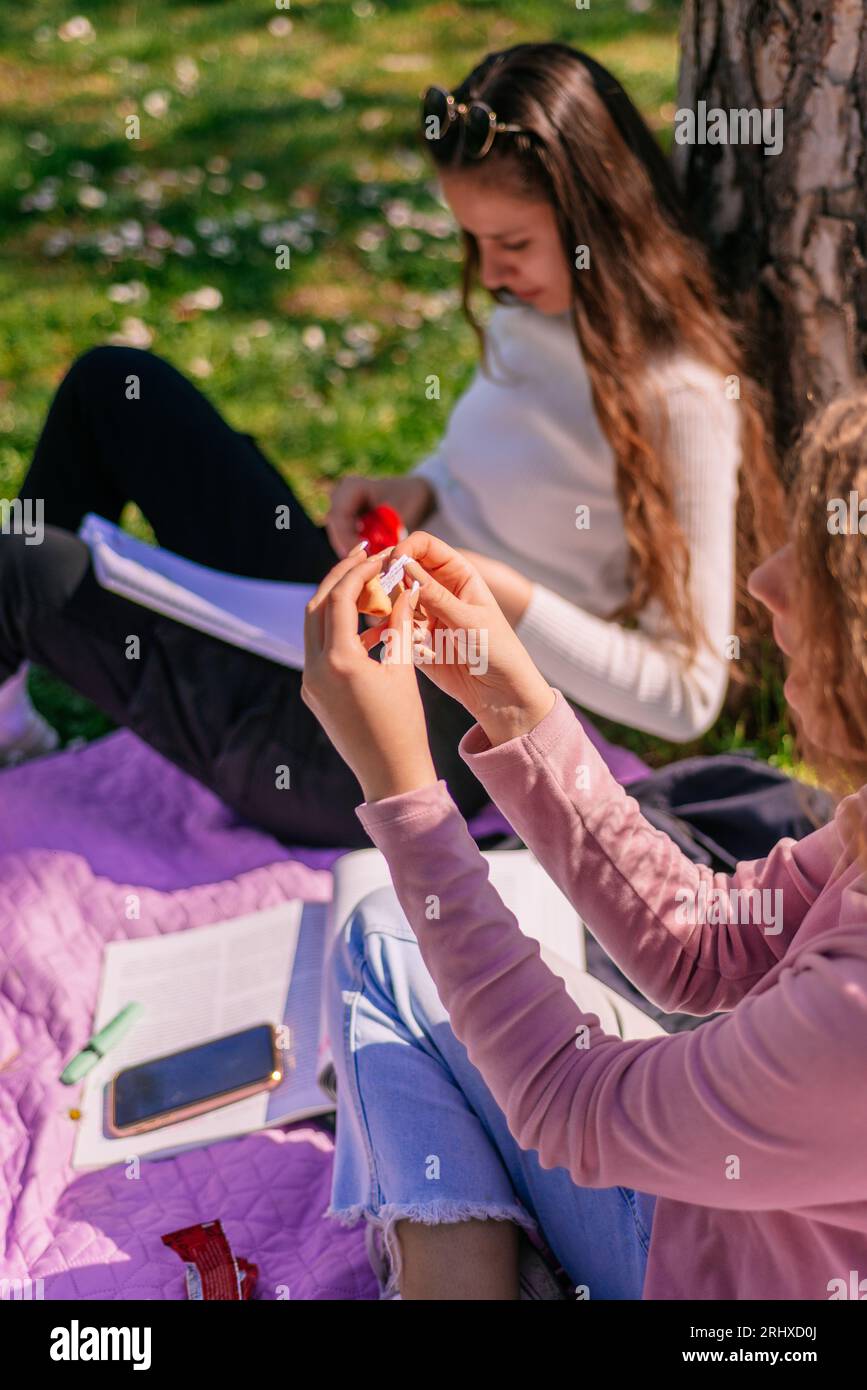 Curly haired girl reading note from her school crush. She looks ...