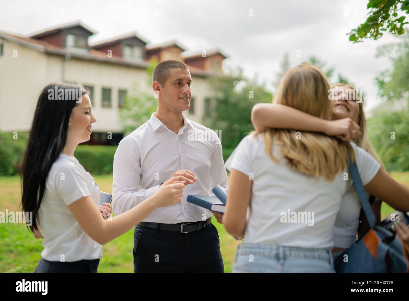 Group of teenage high school students standing outside, hugging ...