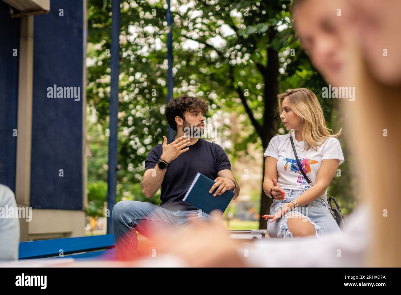 Students discussing university project, male students explaining ...