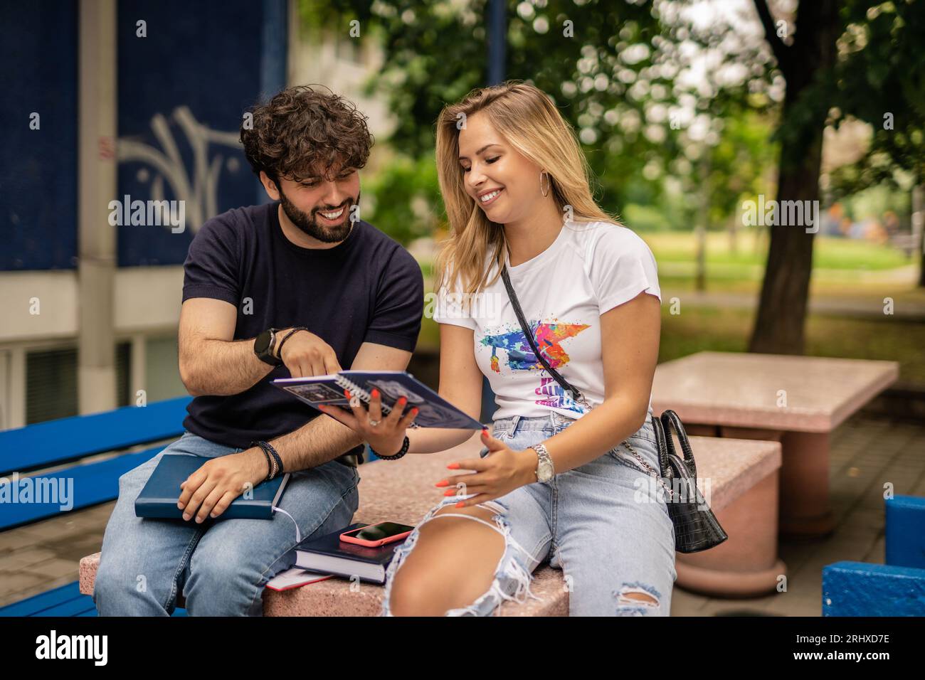 Happy, positive couple, university colleagues, studying together ...