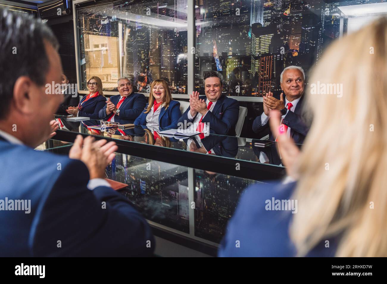 Happy, successful, mature business leaders gathered at table in modern ...