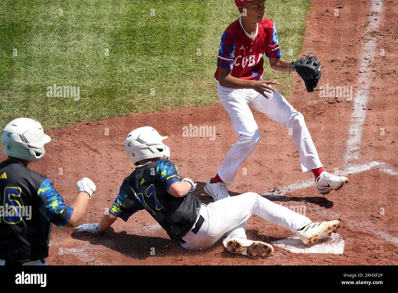 Australia's Jet Creamer (17) scores on a passed ball as Cuba's pitcher ...
