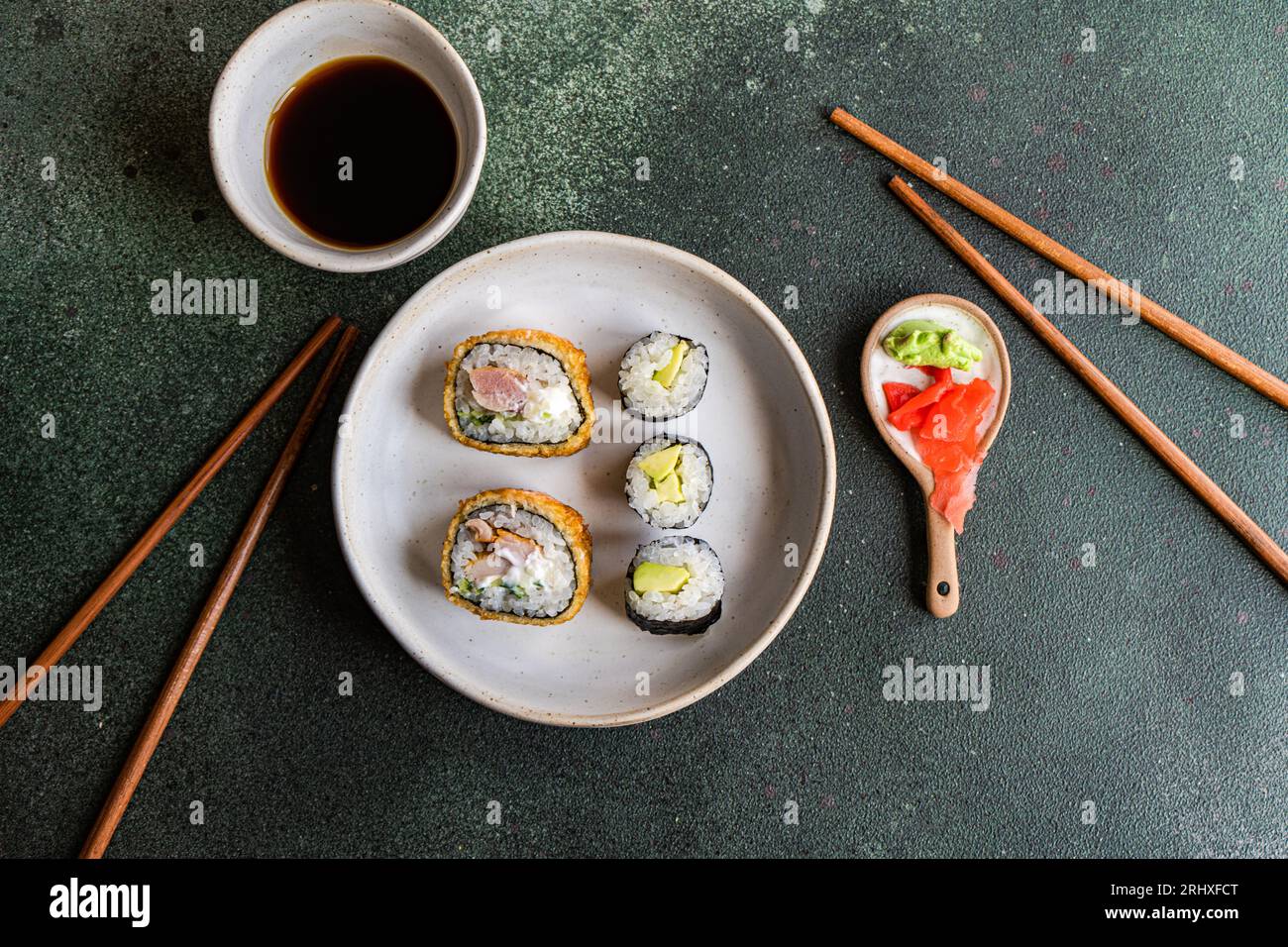 From above of japanese food set with avocado maki roll and fried sushi ...