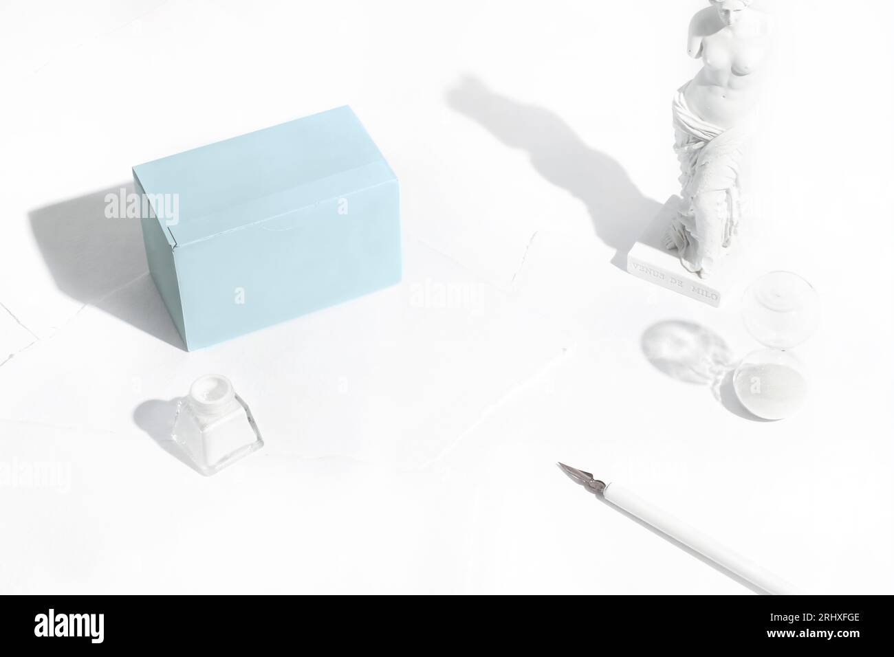 High angle of composition with tea boxes, classic sculpture, writing ...