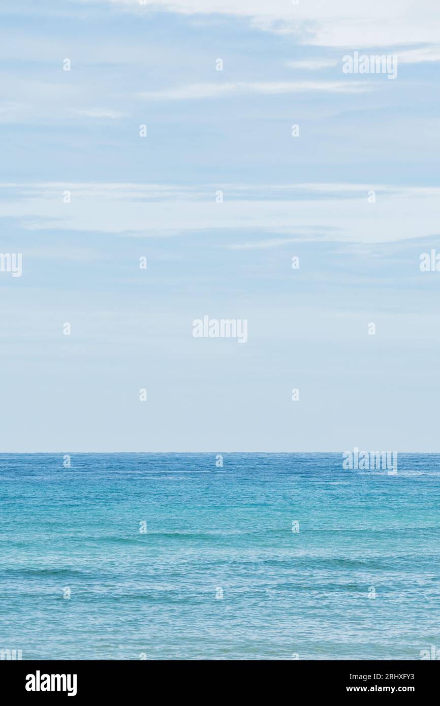 Scenic view of blue wavy ocean water with horizon line under cloudy ...
